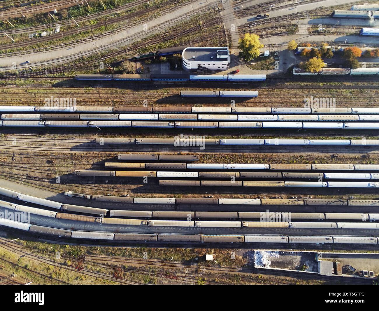 Aerial view of railroad yard with passenger and cargo trains on rail ...