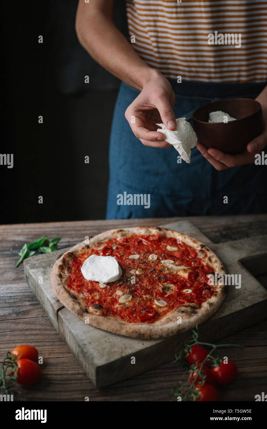 Hand holding pizza hi-res stock photography and images - Alamy