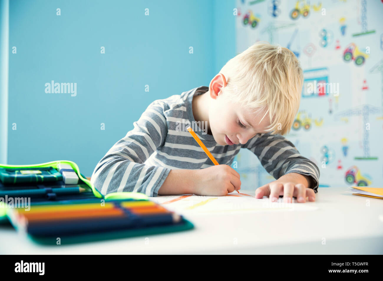 Focused boy doing homework desk hi-res stock photography and images - Alamy