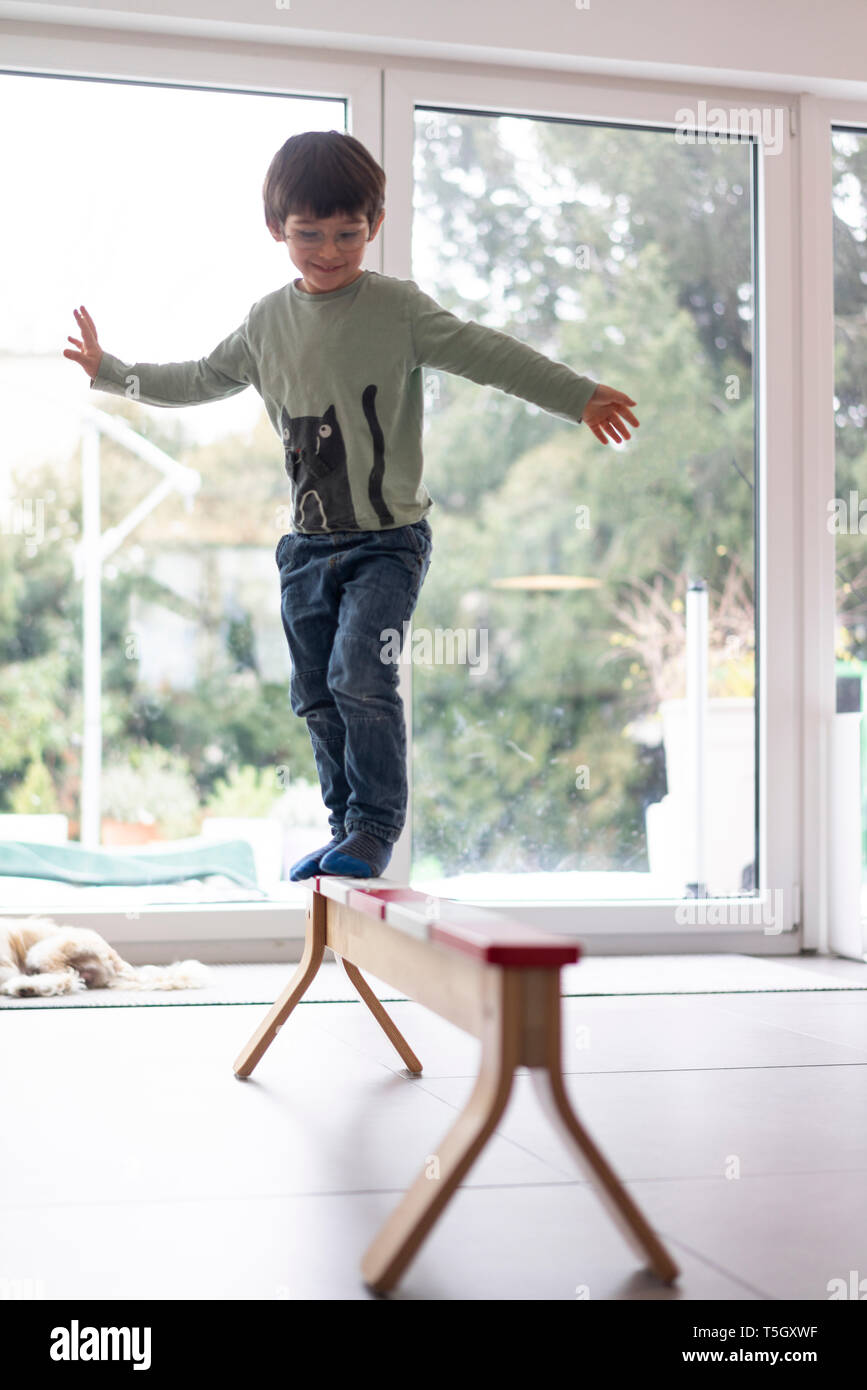 Little boy balancing on a beam Stock Photo - Alamy
