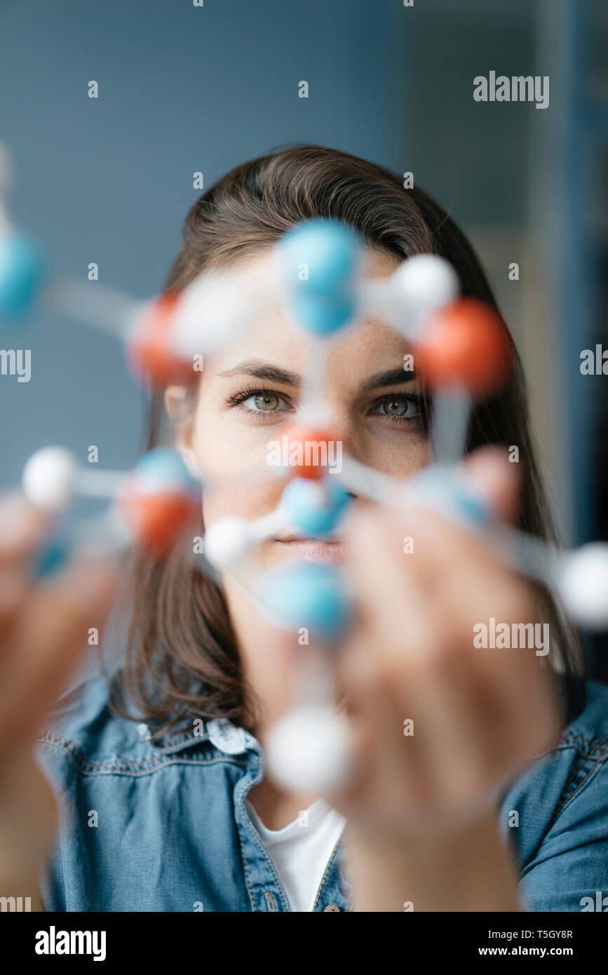 Female scientist looking at molecule model hi-res stock photography and ...
