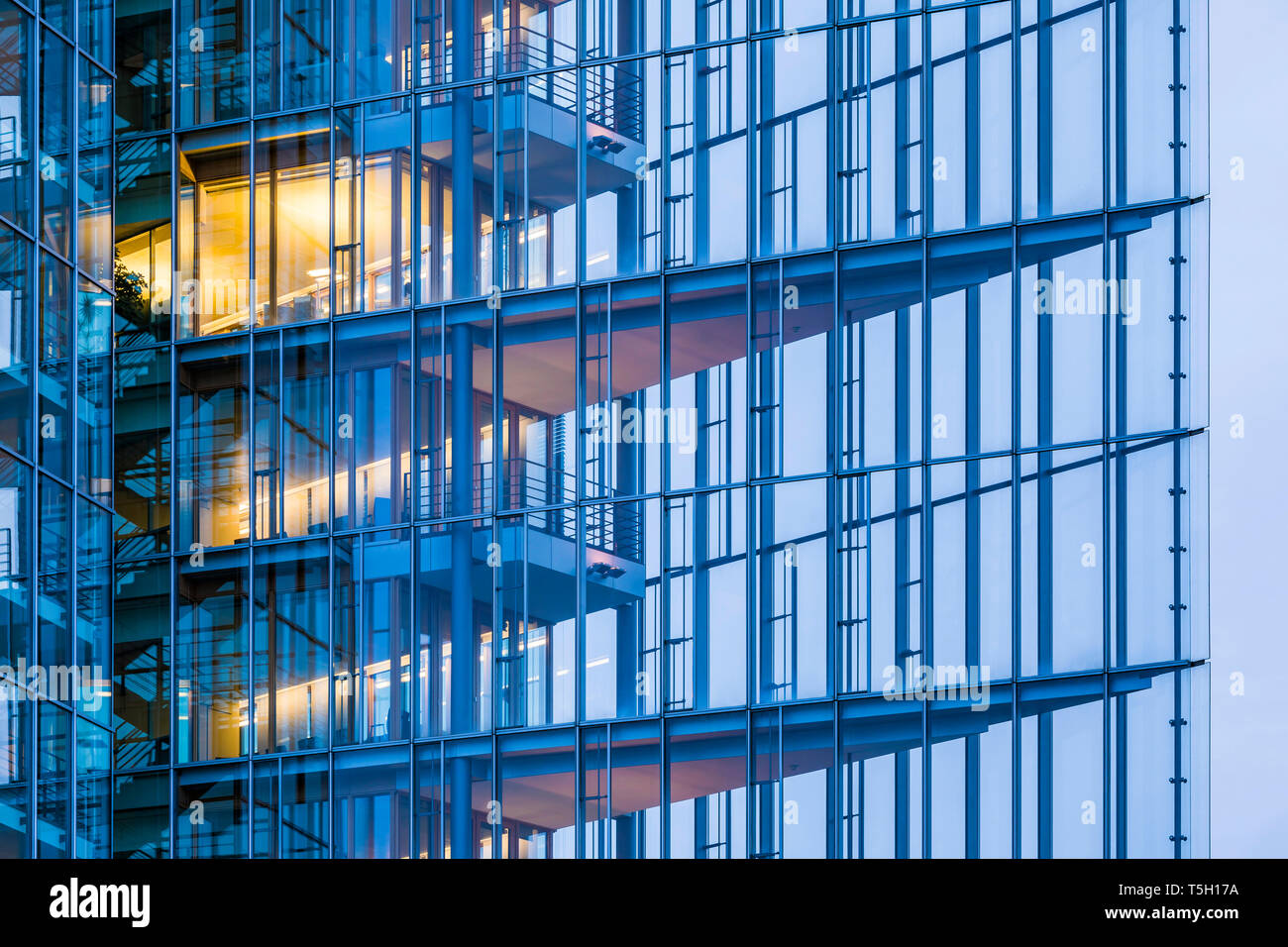 Germany, Stuttgart, lighted office at modern office building Stock ...