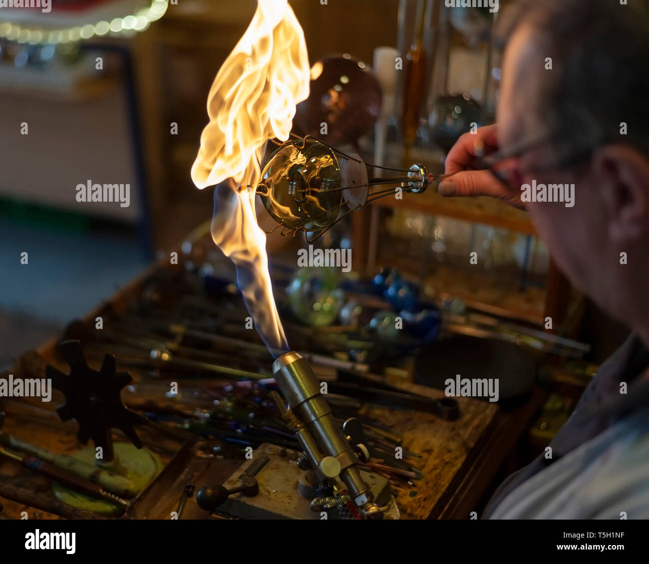 Glass blower forming melting glass Stock Photo - Alamy