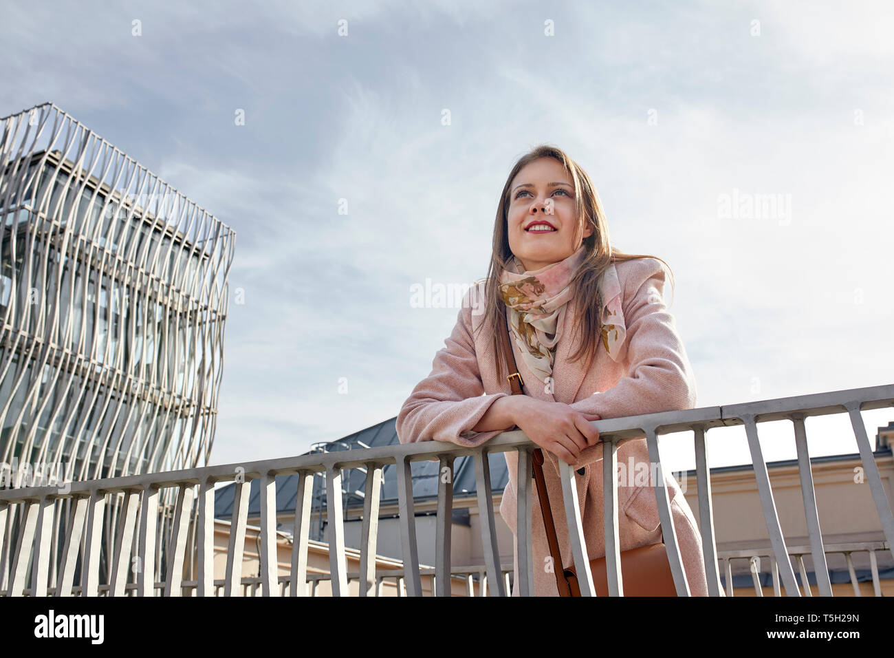 Austria, Vienna, portrait of smiling young woman at Museumsquartier ...
