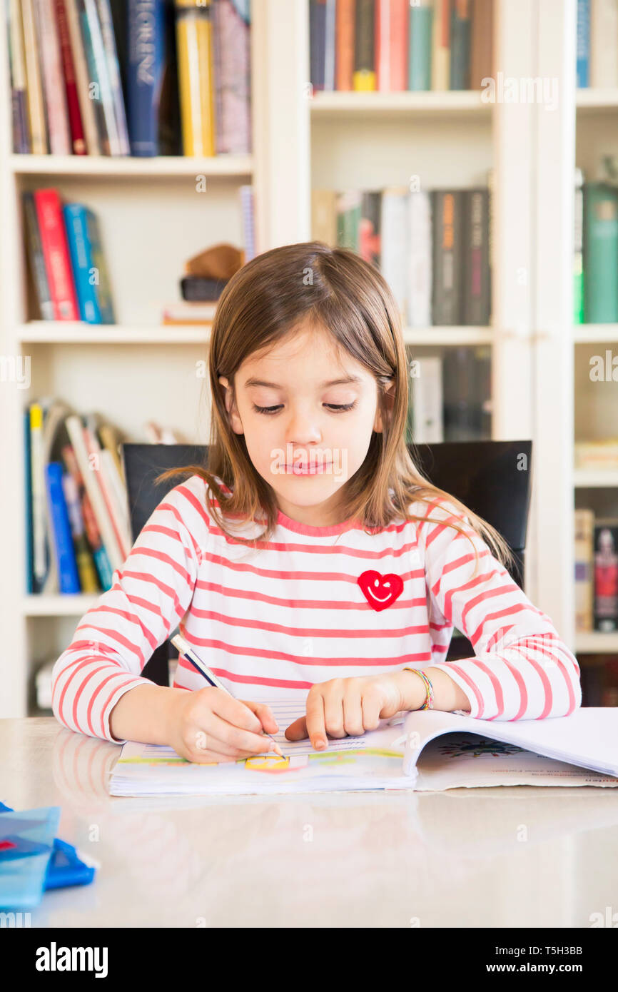 Portrait of little girl doing homework Stock Photo - Alamy