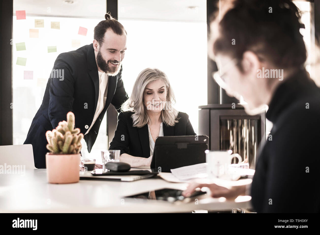 Business people working together in office, businessman watching ...