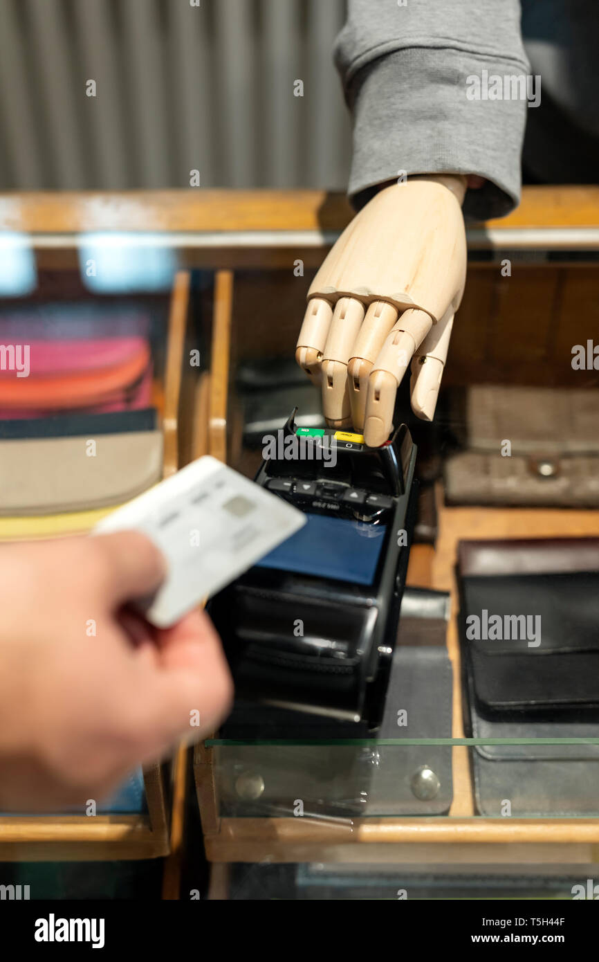 Customer paying with creditcard, robot assisting Stock Photo - Alamy