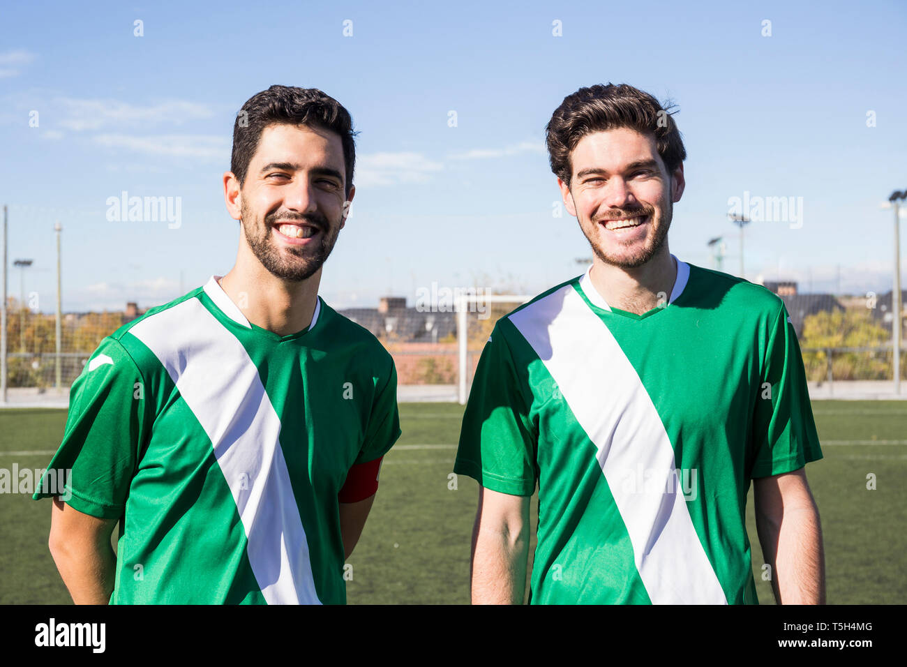 Portrait of two confident football players on football field Stock ...