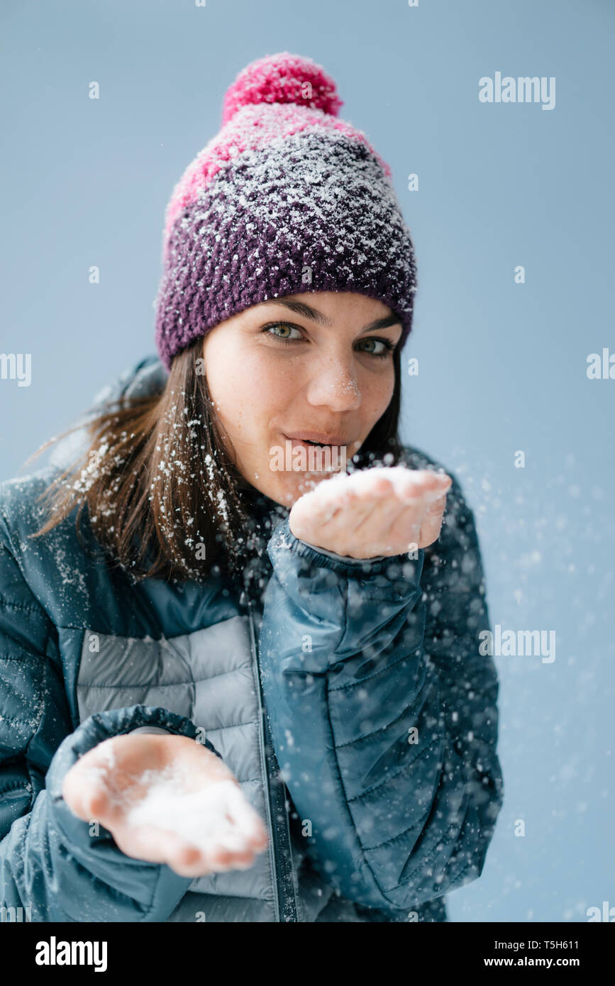 Woman wearing wooly hat, blowing snow Stock Photo - Alamy