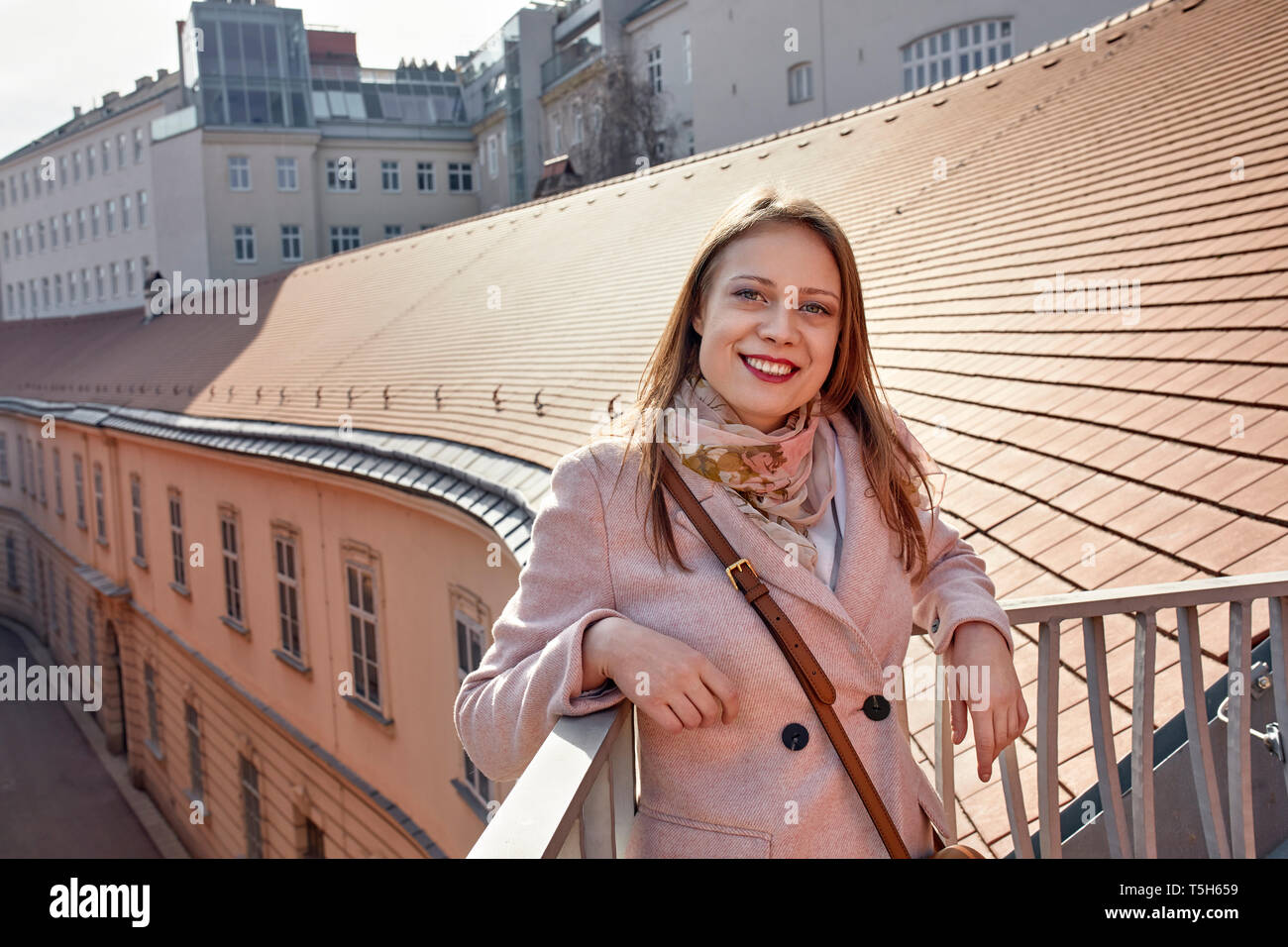 Austria, Vienna, portrait of smiling young woman at MuseumsQuartier ...