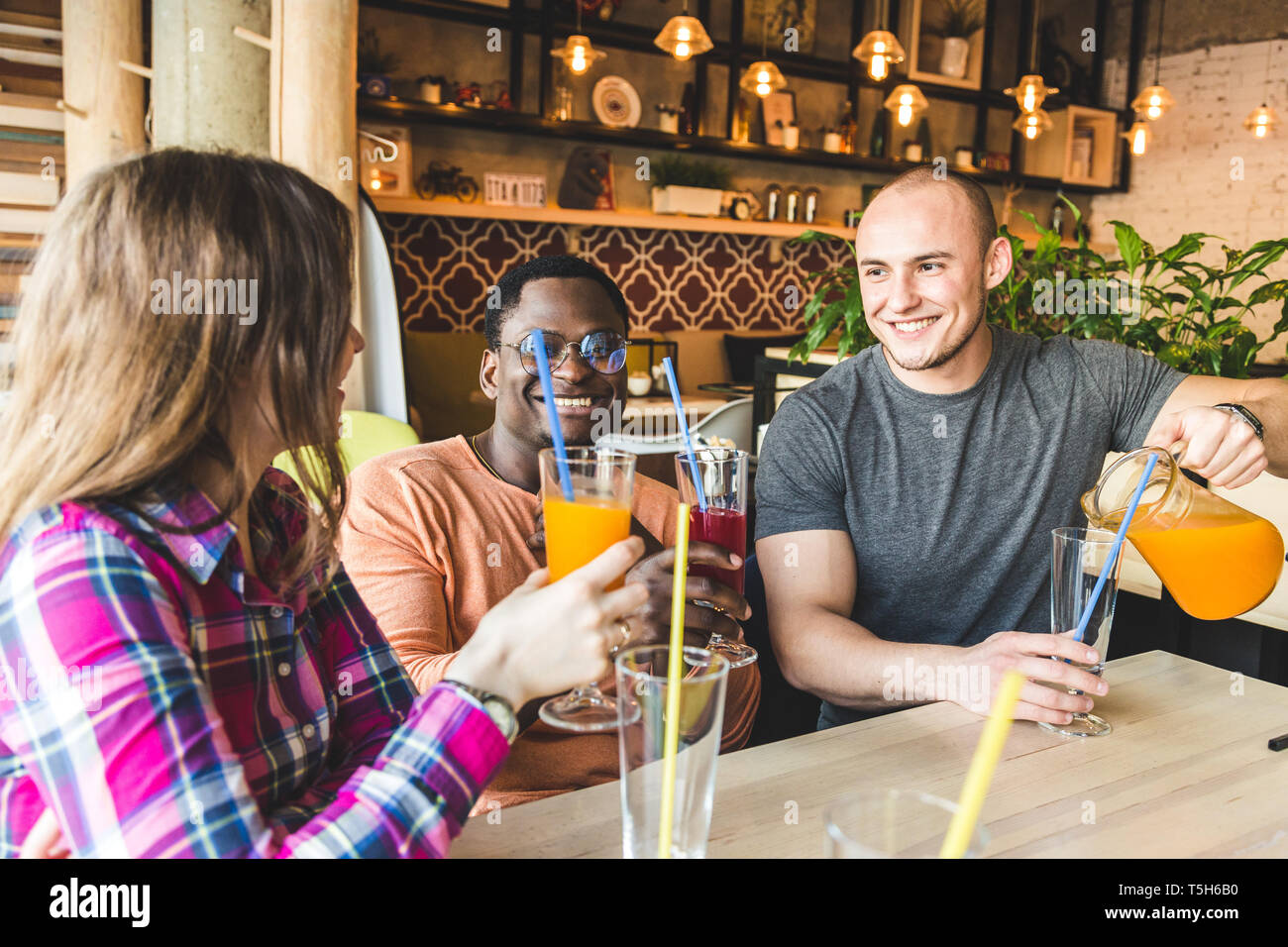 A company of young people having fun, drinking drinks, cocktails ...