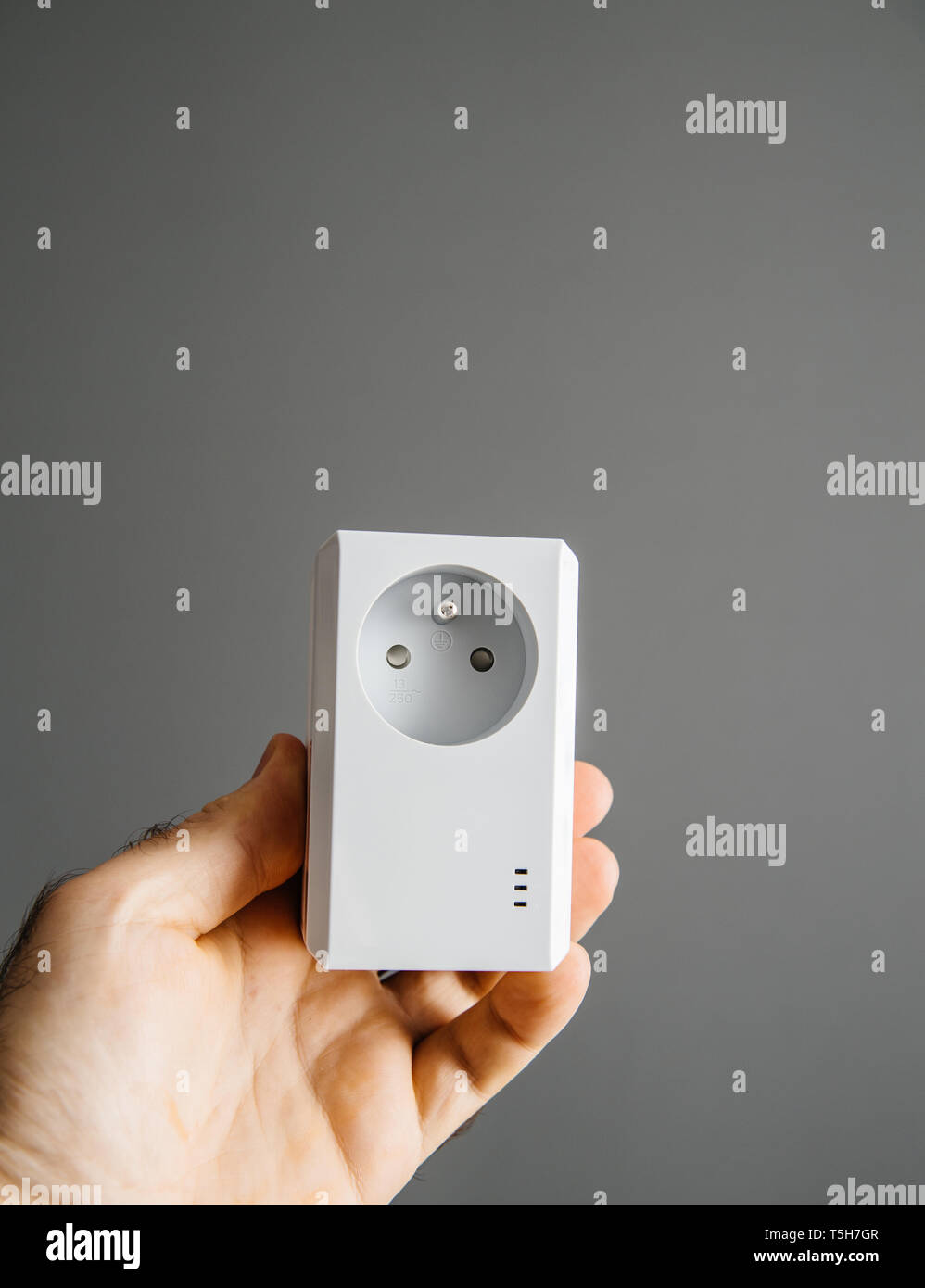 Man hand holding against gray background a new modern powerful ...