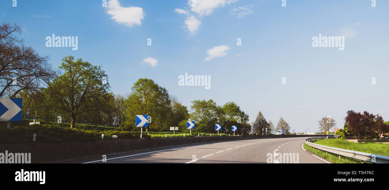 Blue arrows on French autoroute highway with one van driving in ...