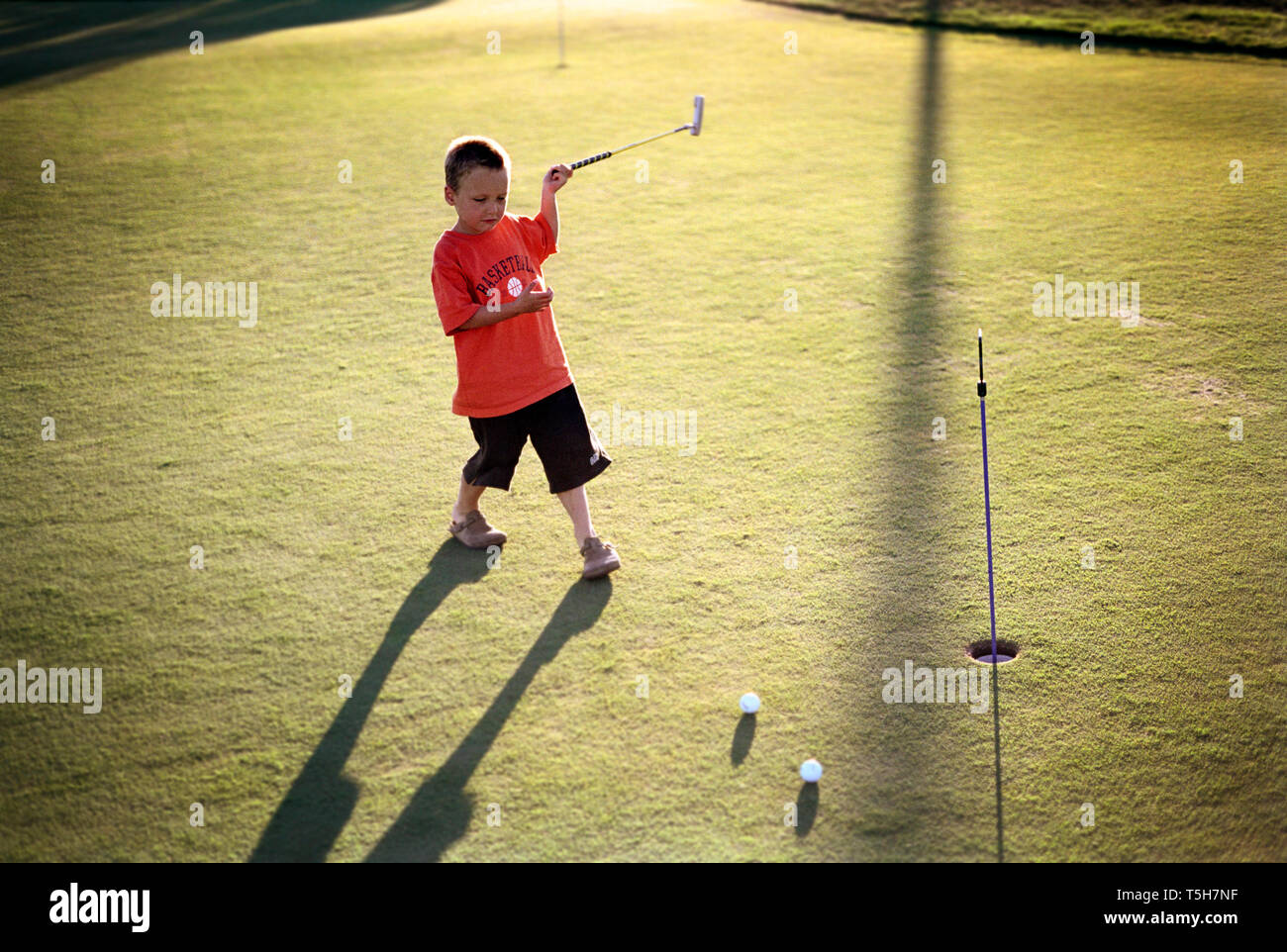 Boy playing golf Stock Photo - Alamy