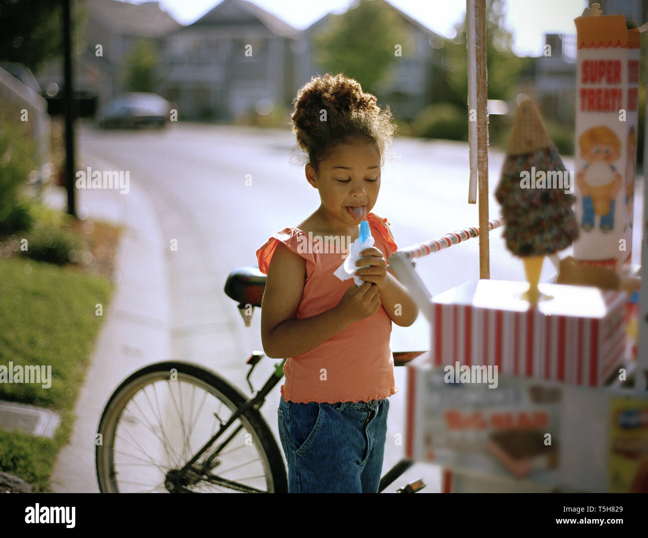 Girl licking popsicle hi-res stock photography and images - Alamy