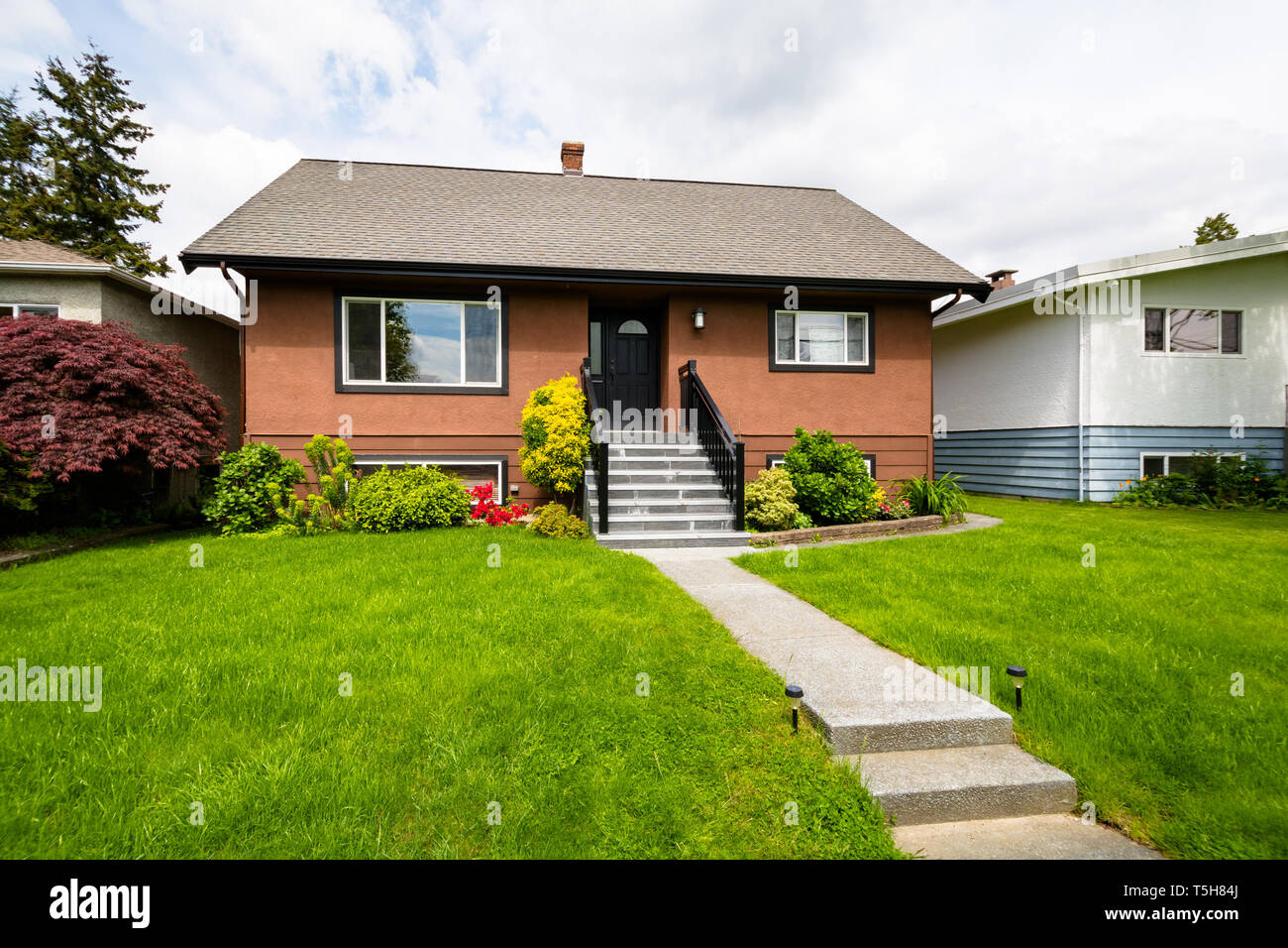 Average brown residential house built on land terrace Stock Photo - Alamy