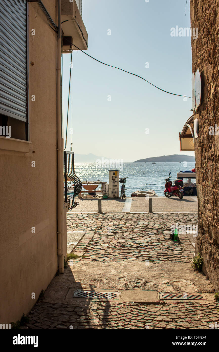 a narrow view of sea between old buildings. photo has taken at izmir ...