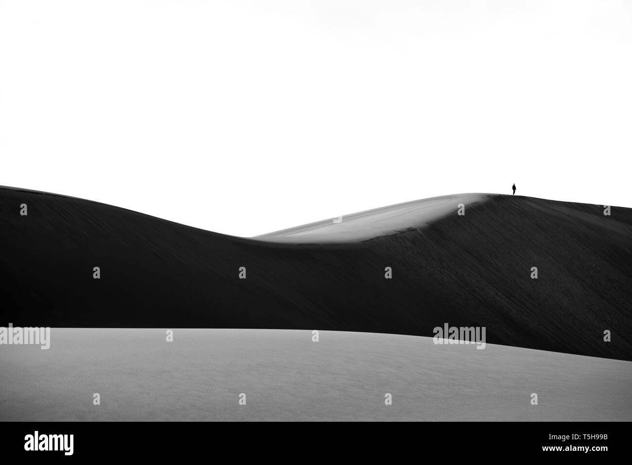 Small Man Hiking on Sand Dunes Stock Photo - Alamy