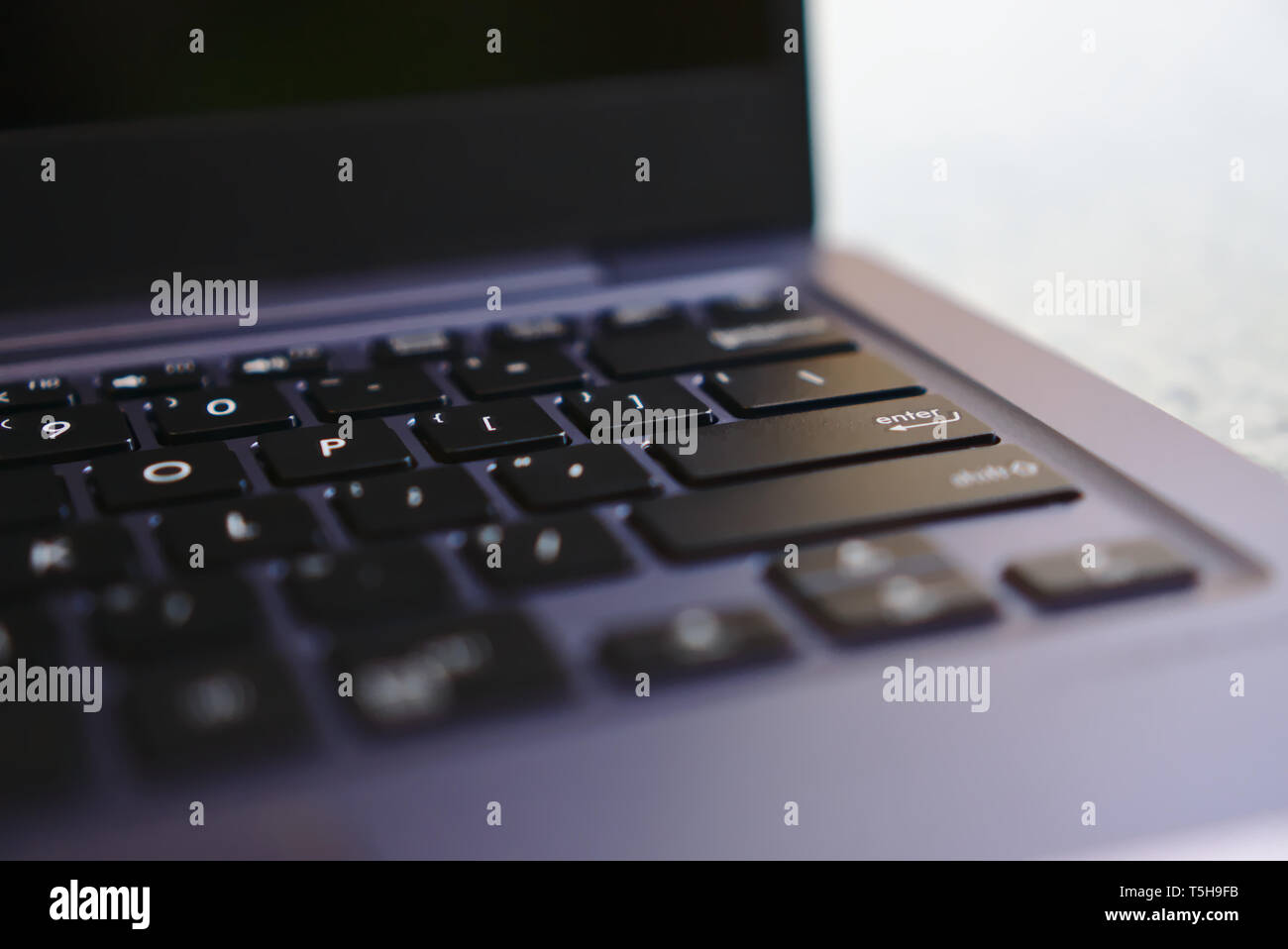 Part view of laptop keyboard with clear enter key Stock Photo - Alamy