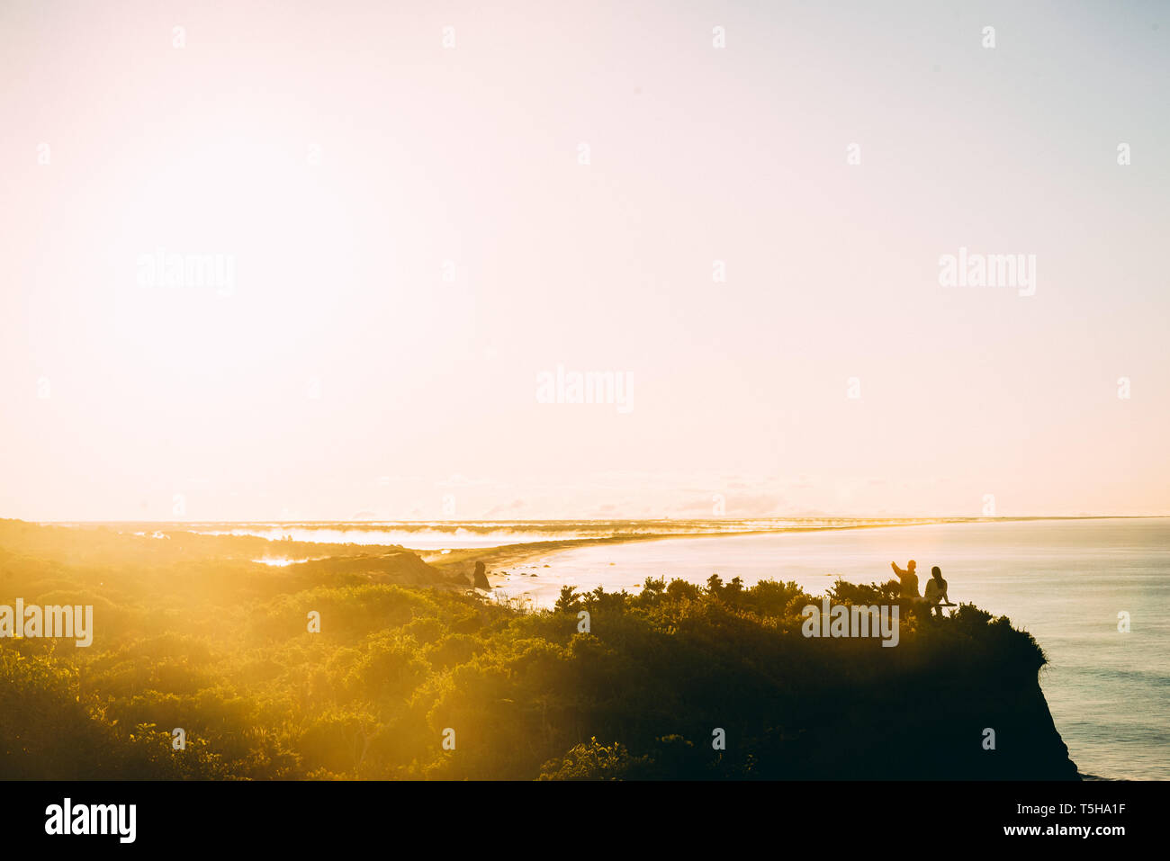 Romantic Couple Silhouette on Cliff Next to Ocean Stock Photo - Alamy