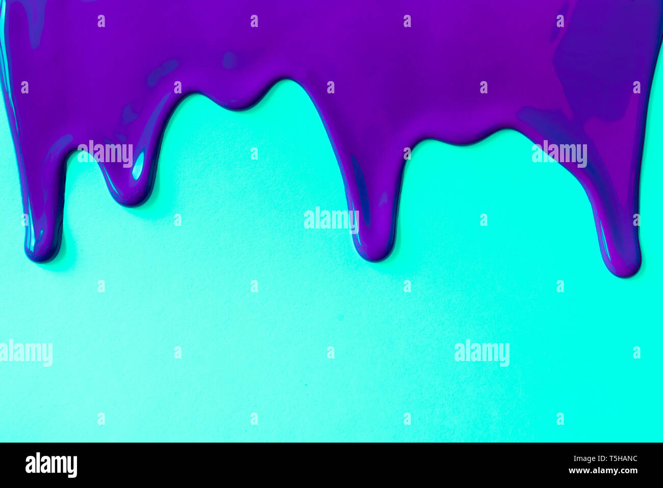 Blue paint leaking down cyan background. Close up Stock Photo - Alamy