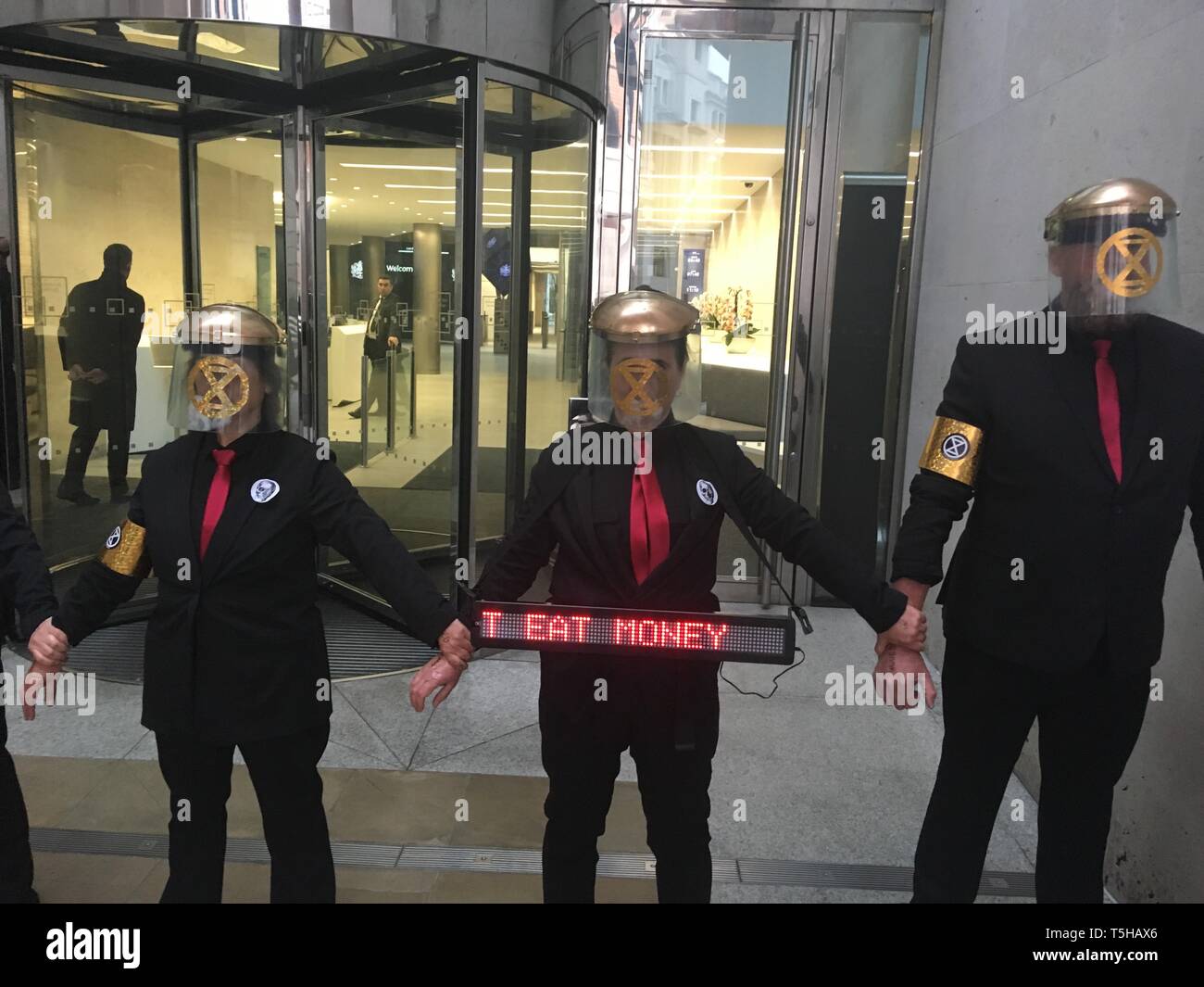 Protesters from Extinction Rebellion glue themselves to the London ...