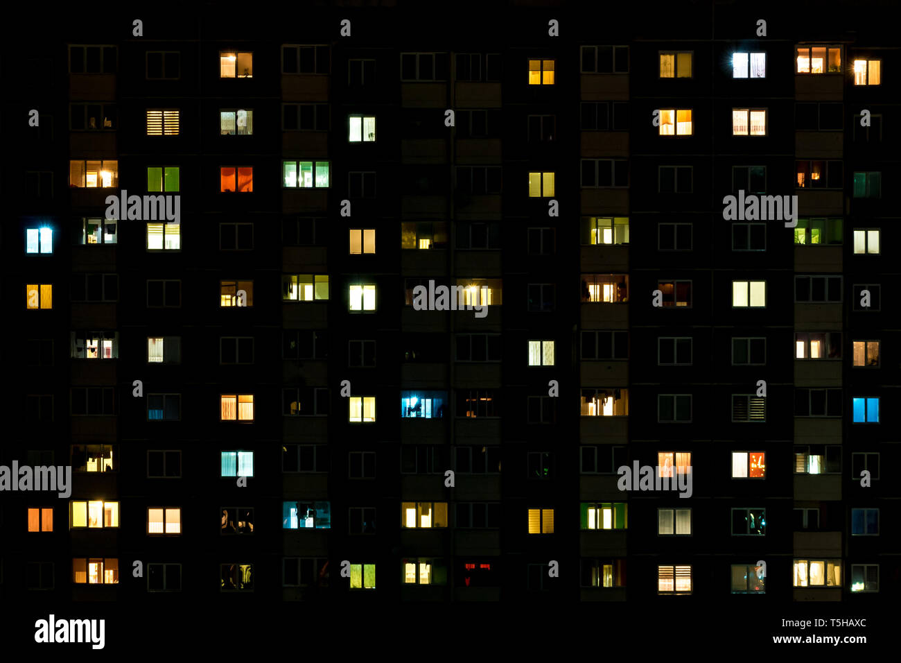 Night time lapse of Light in the windows of a multistory building. life ...