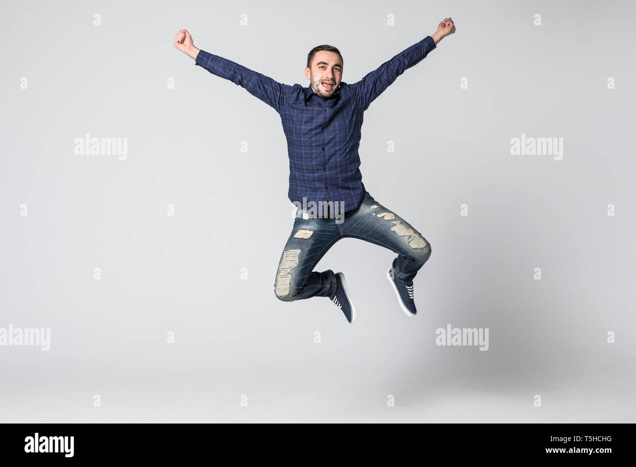 Smiling joyful man jumping isolated on white background Stock Photo - Alamy