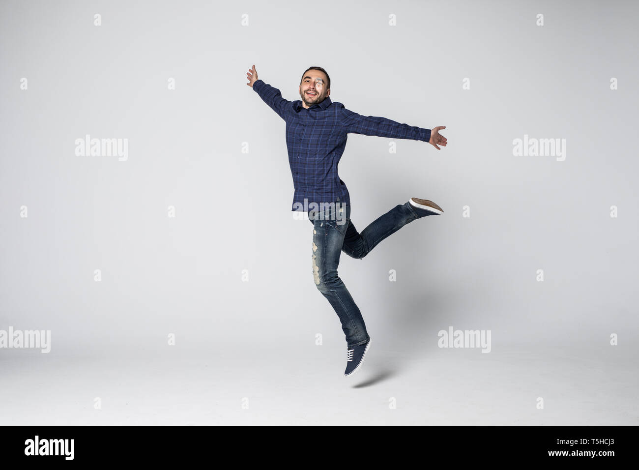 Happy excited cheerful young man jumping and celebrating success ...