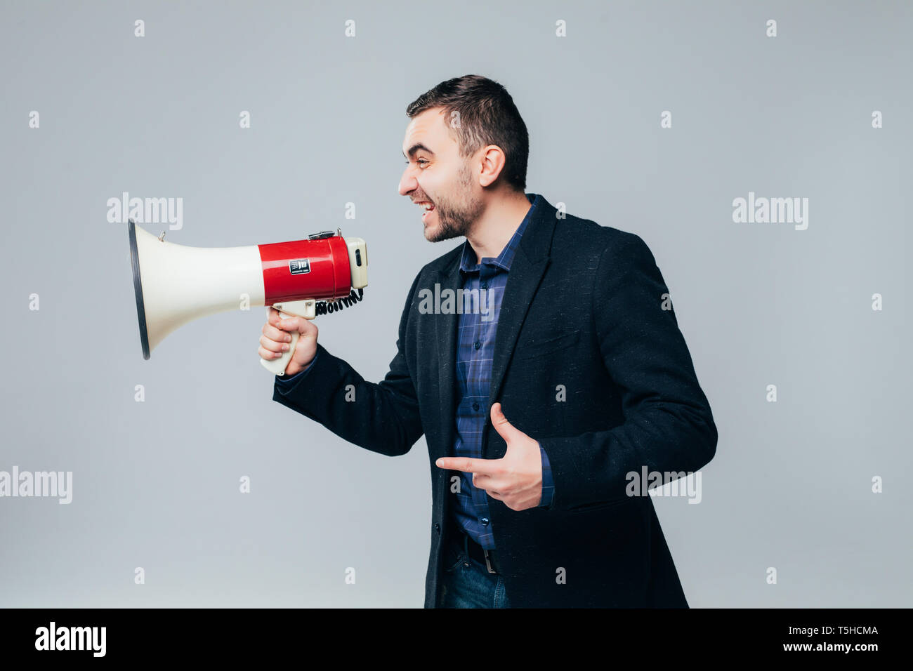 Businessman shouting by megaphone isolated on white background Stock ...