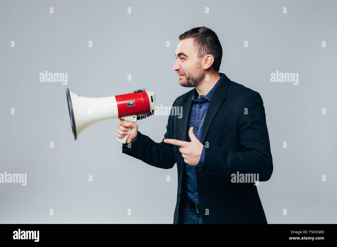 Businessman shouting by megaphone isolated on white background Stock ...