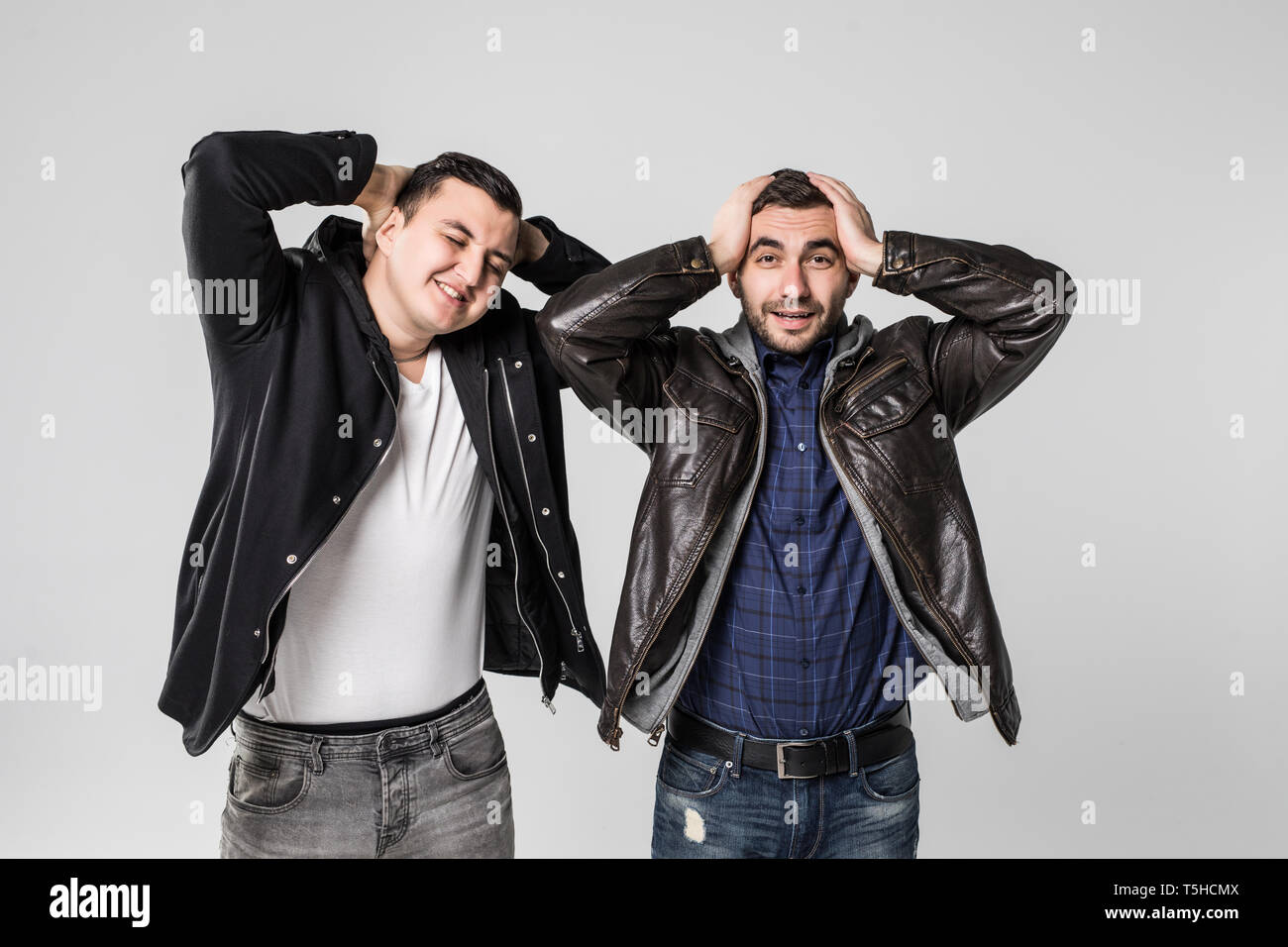 Two young upset men looking friend isolated over white background Stock ...