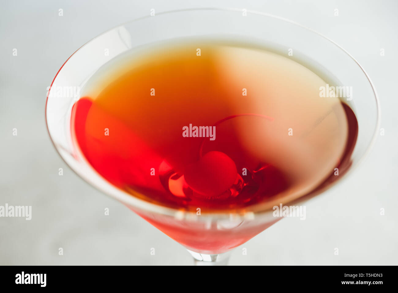 Manhattan cocktail with bourbon and maraschino cherry garnish on a ...