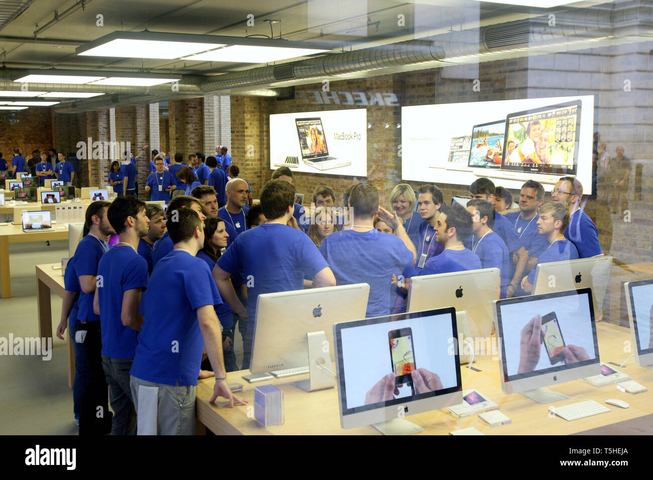 Staff having a team talk before Apple opens a new store in Covent ...
