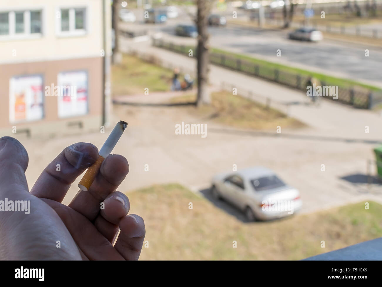View of the hand of a Smoking man with a Smoking cigarette from the ...