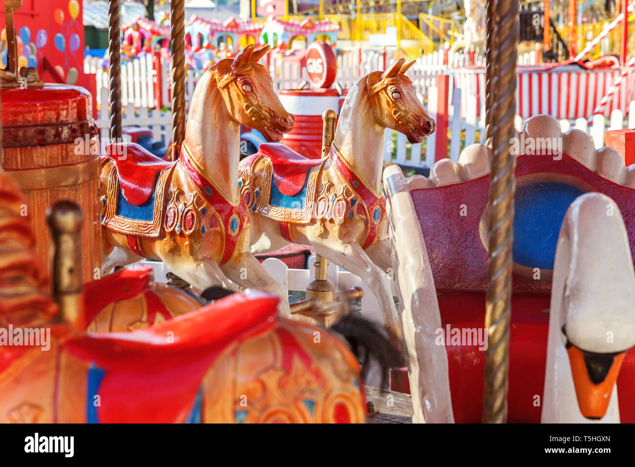 Children outdoor colourful vintage Merry-Go-Round flying horse carousel ...