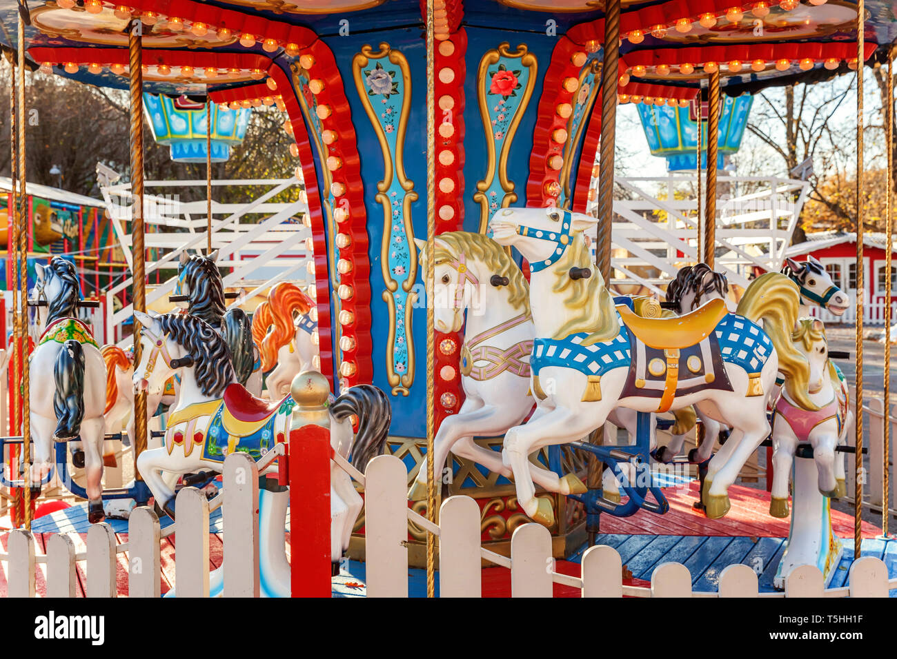 Children outdoor colourful vintage Merry-Go-Round flying horse carousel ...