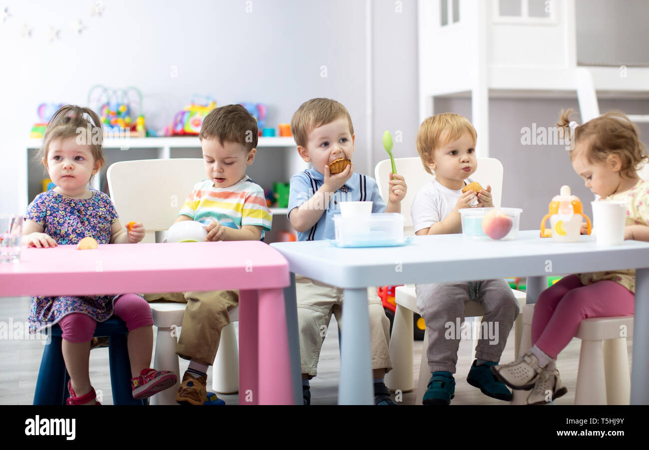 Group of babies have lunch in nursery Stock Photo - Alamy