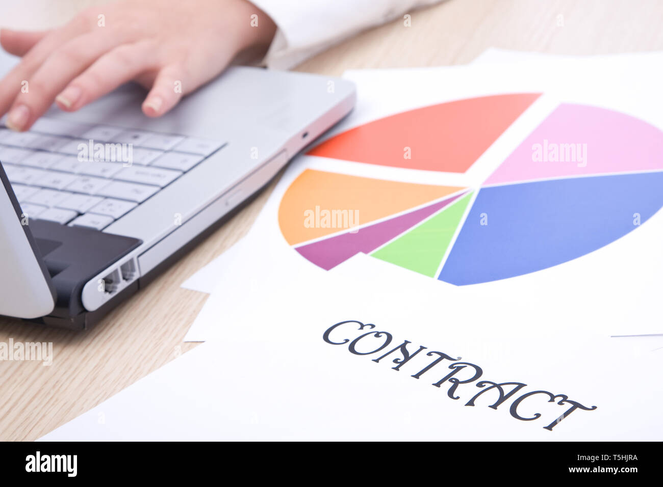 business contract form with modern laptop and chart Stock Photo - Alamy