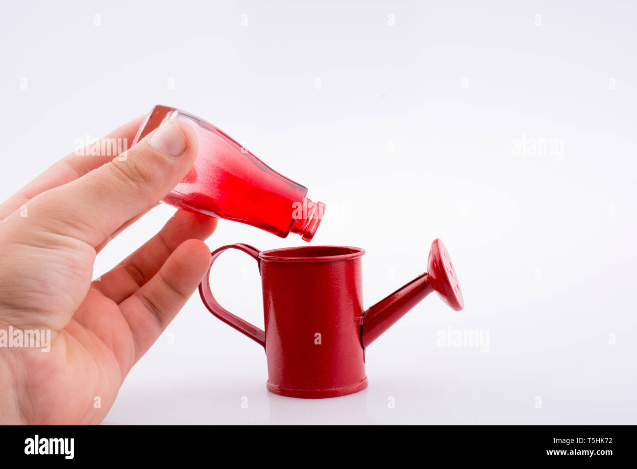 Hand holding a watering can without water on a white background Stock ...