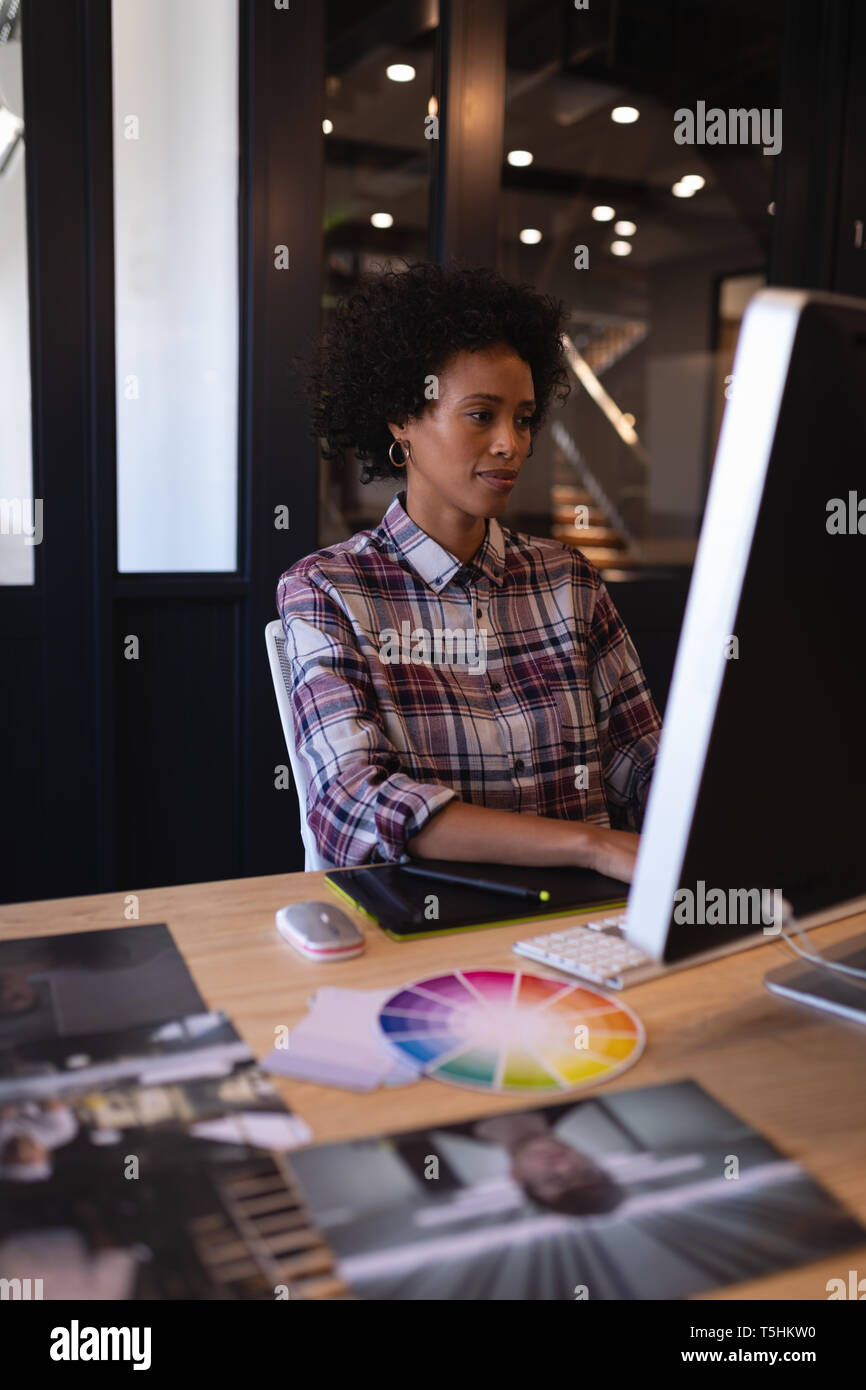Female graphic designer working on computer in office Stock Photo - Alamy