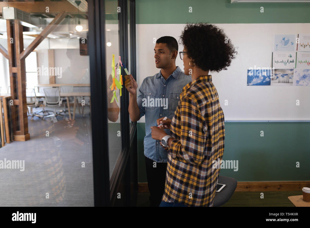 Business people writing on sticky notes in office Stock Photo - Alamy