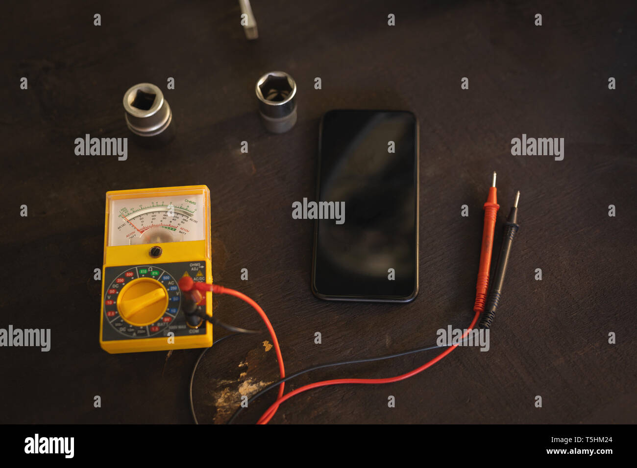 Motor testing multimeter and mobile phone at floor Stock Photo - Alamy