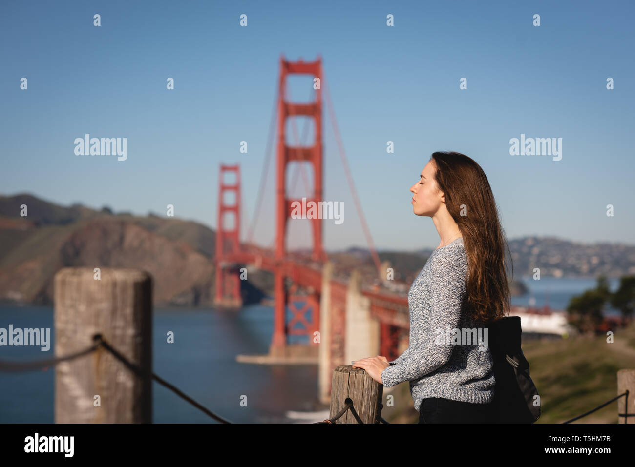 Beautiful woman standing near railing Stock Photo - Alamy