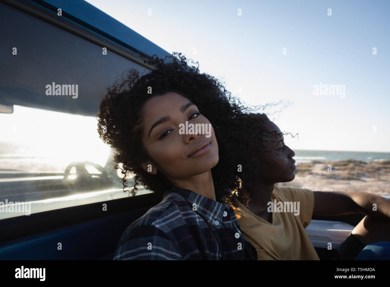 Couple relaxing in car at beach Stock Photo - Alamy