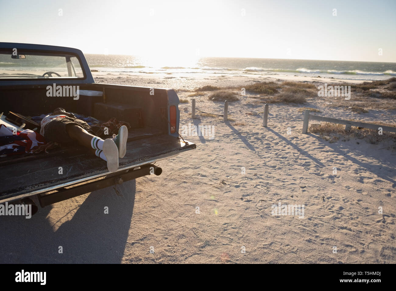 Young man lying at the beach hi-res stock photography and images - Alamy