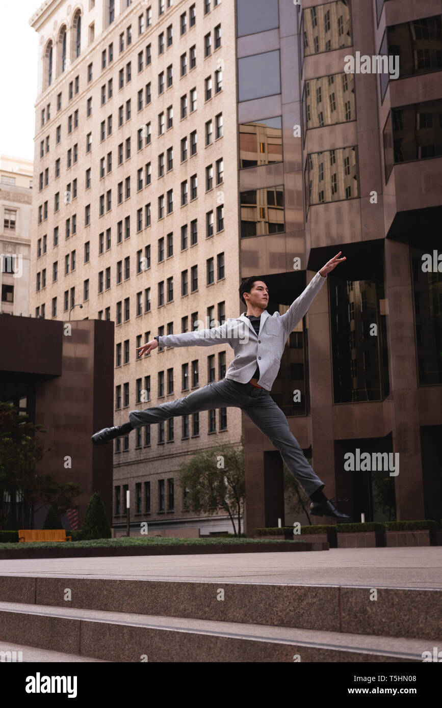 Handsome man jumping and dancing on stairs Stock Photo - Alamy