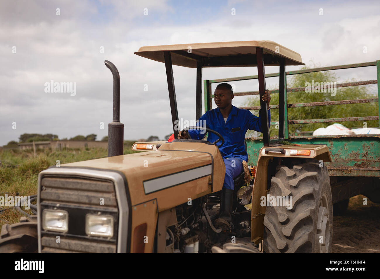 Farmer driving tractor hi-res stock photography and images - Alamy