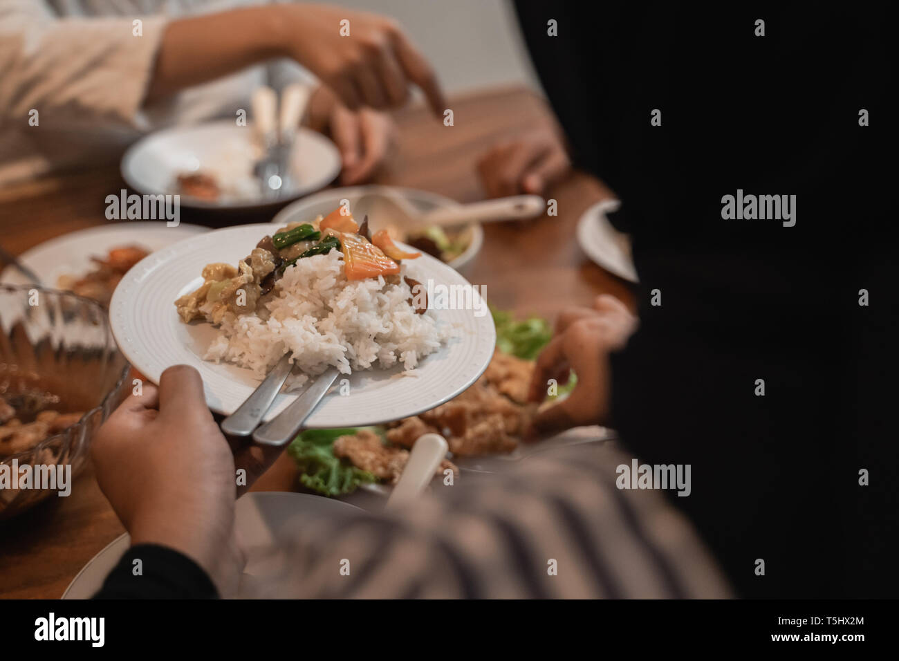 hand pick some food during dinner Stock Photo - Alamy