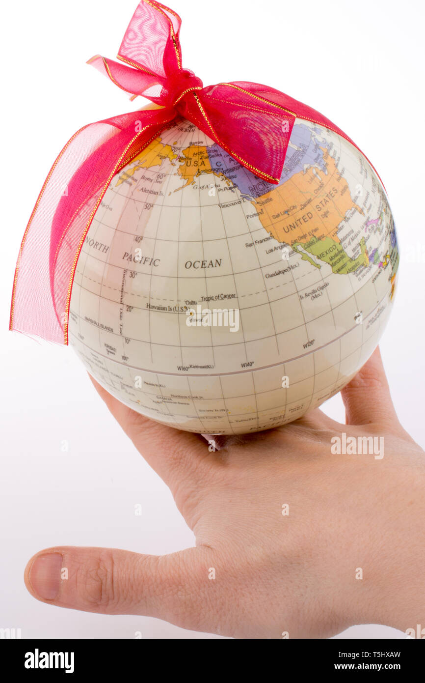 Globe tied with red ribbon on a white background Stock Photo - Alamy